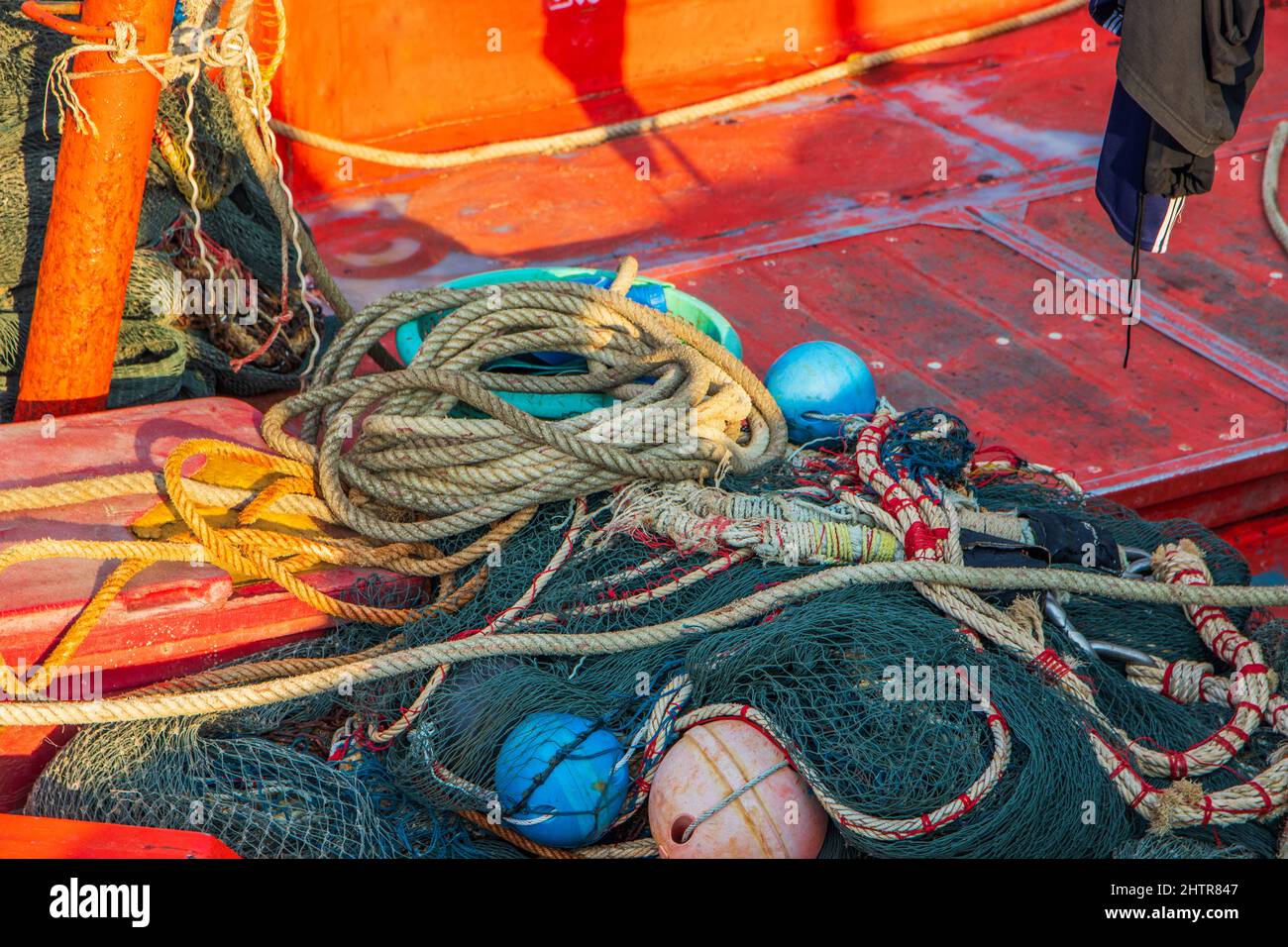 A fishing net with ropes and cord on the deck Stock Photo - Alamy