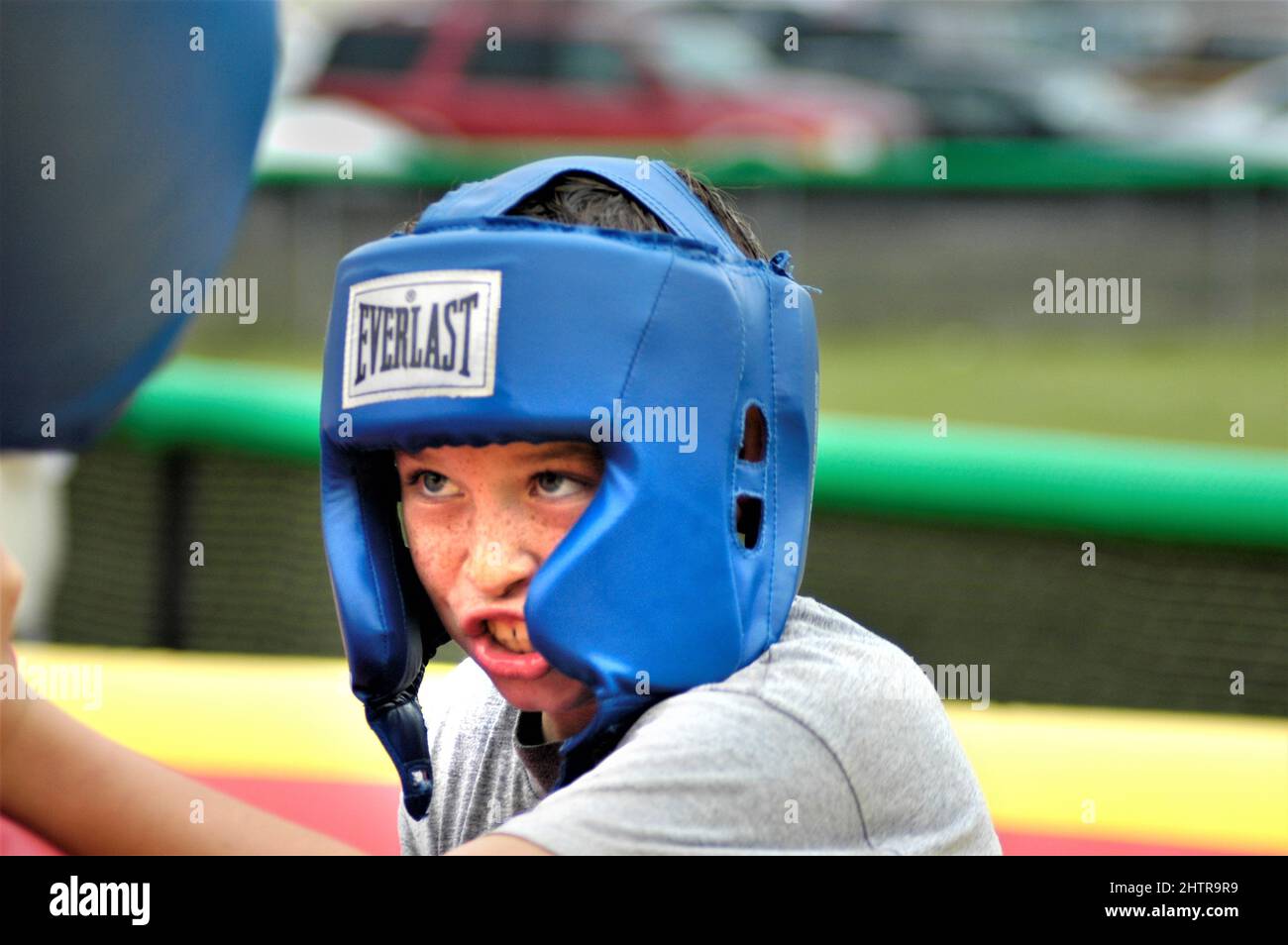 Kid learning to fight with headgear for protection Stock Photo - Alamy