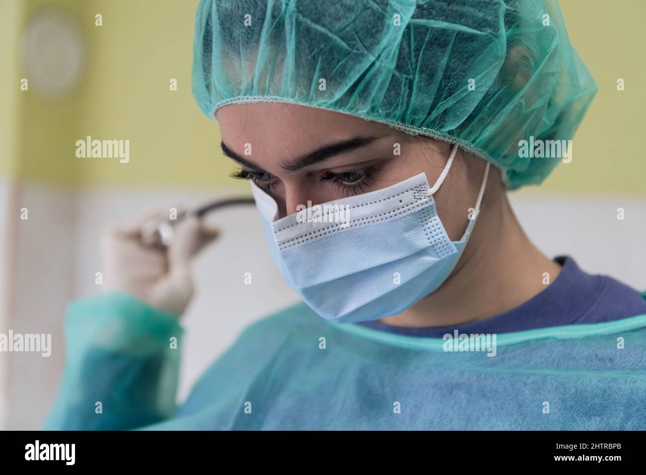 Portrait of sad and overwhelmed doctor wearing protective face mask ...