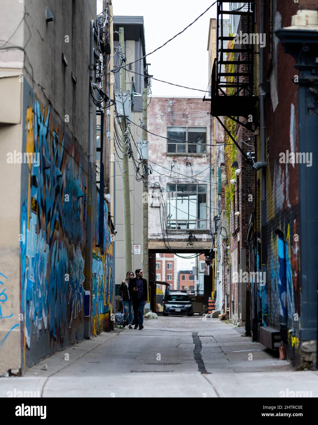 Closeup of an ally in downtown city center with graffiti Stock Photo ...