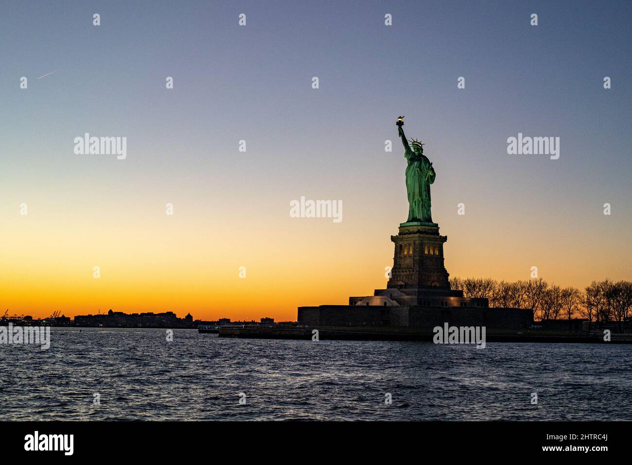 Beautiful view of the Statue of Liberty with buildings in the ...