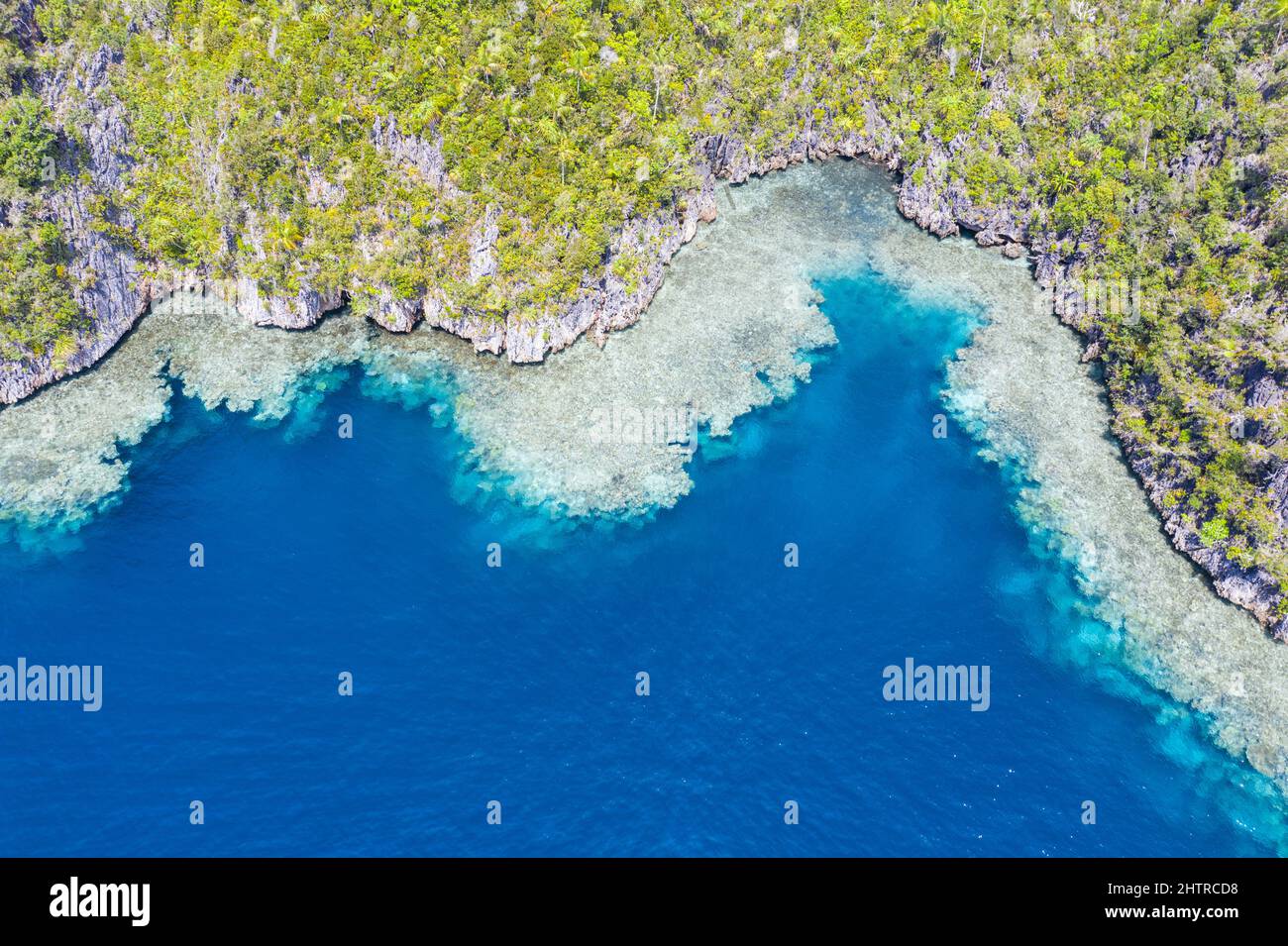 Warm seas surround rugged limestone islands in Raja Ampat, Indonesia ...