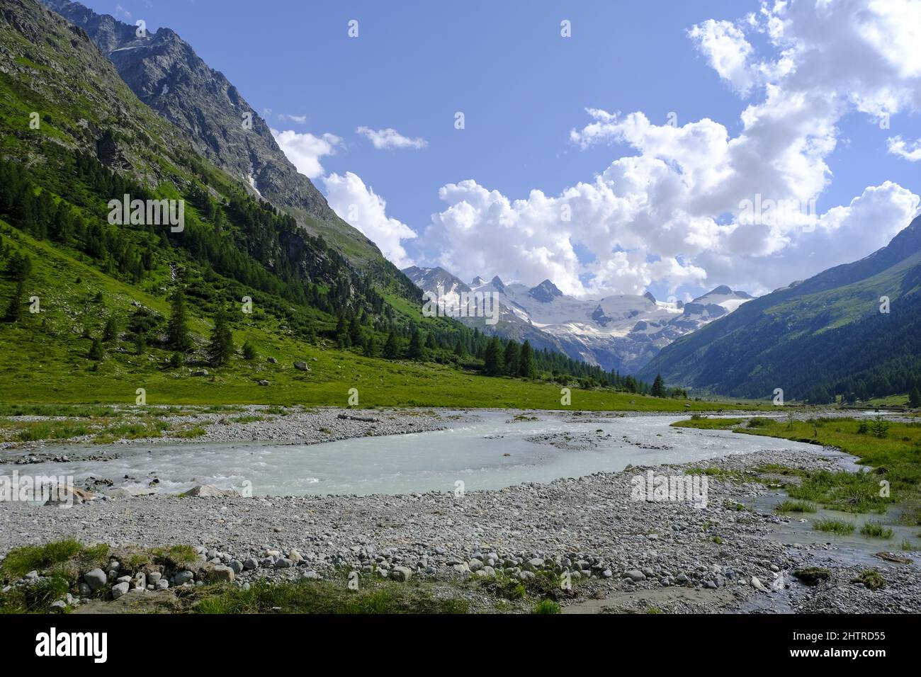 Beautiful shot of a thin river flowing in the middle of mountains in ...