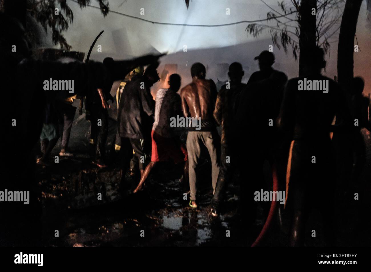 Nairobi, Kenya. 1st Mar, 2022. Residents struggle to put out a night ...
