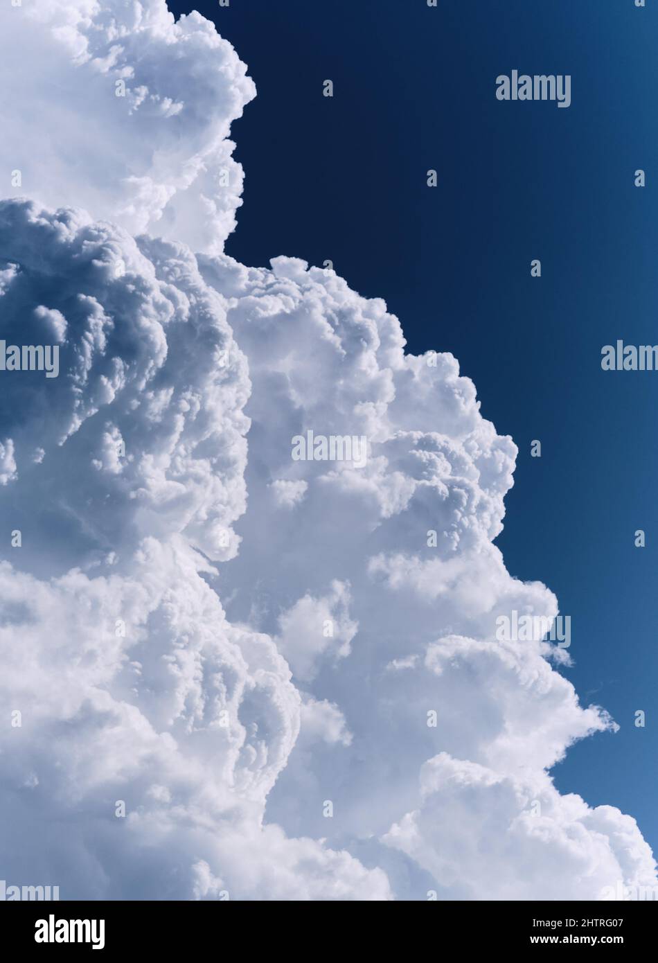 Vertical shot of puffy clouds in the sunny sky Stock Photo - Alamy