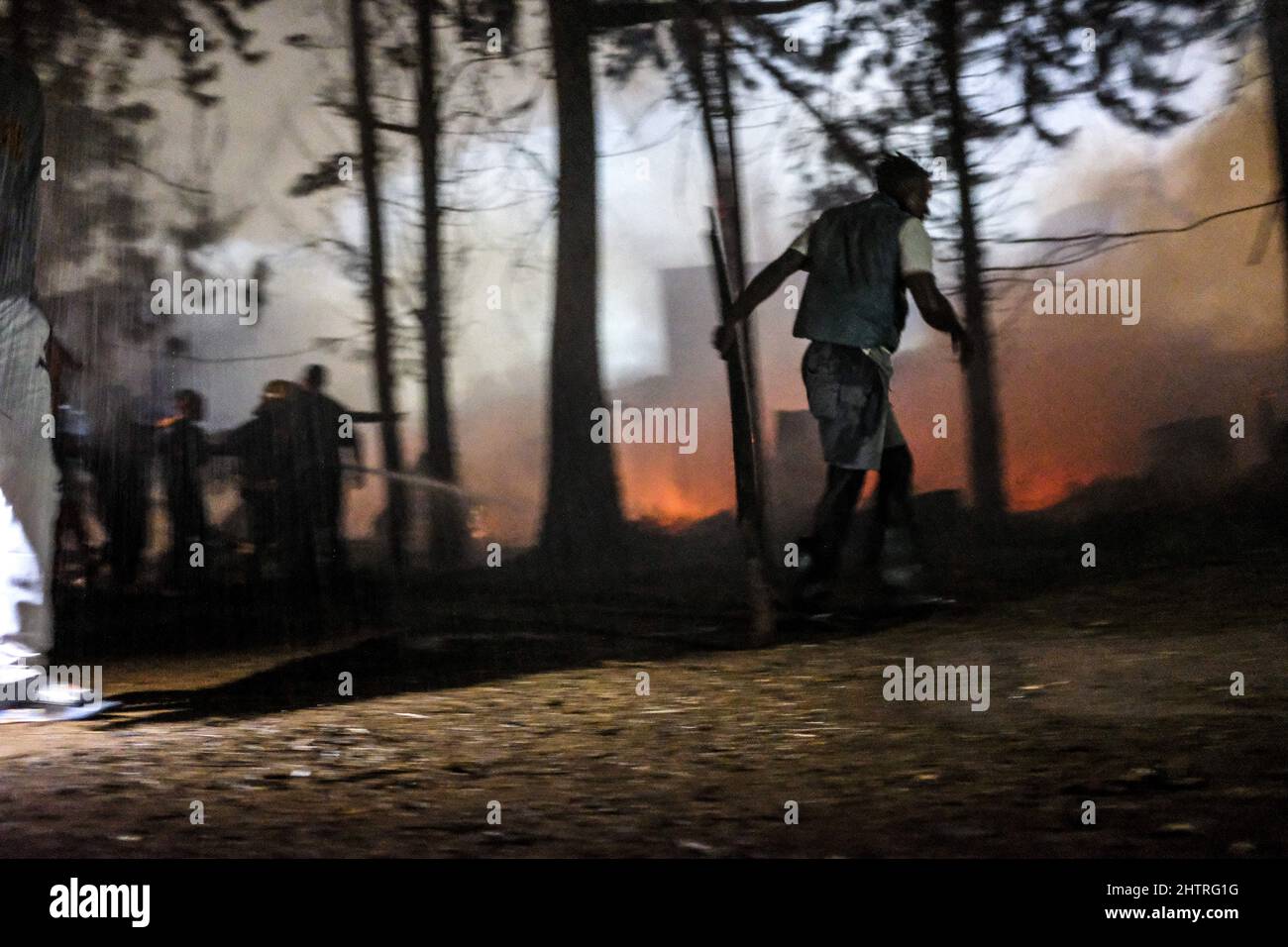 Nairobi, Kenya. 1st Mar, 2022. Residents struggle to put out a night ...