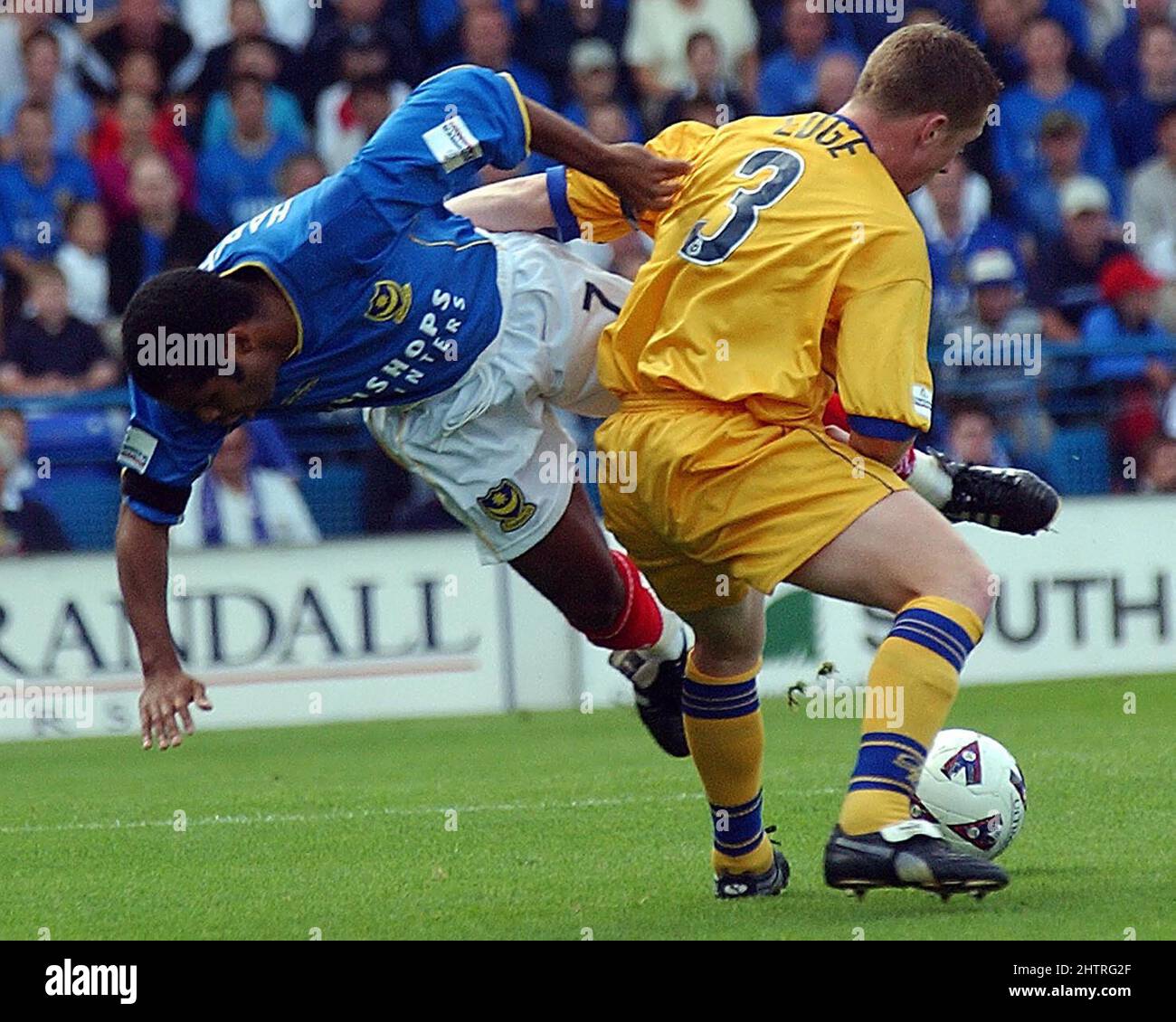 PORTSMOUTH'S KEVIN HARPER IS SENT TUMBLING BY GILLINGHAM'S ROLAND EDGE ...
