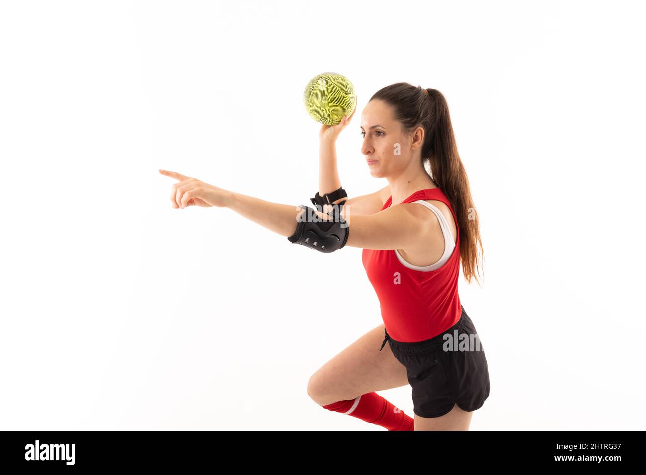 Caucasian young female player with arm outstretched and handball ...