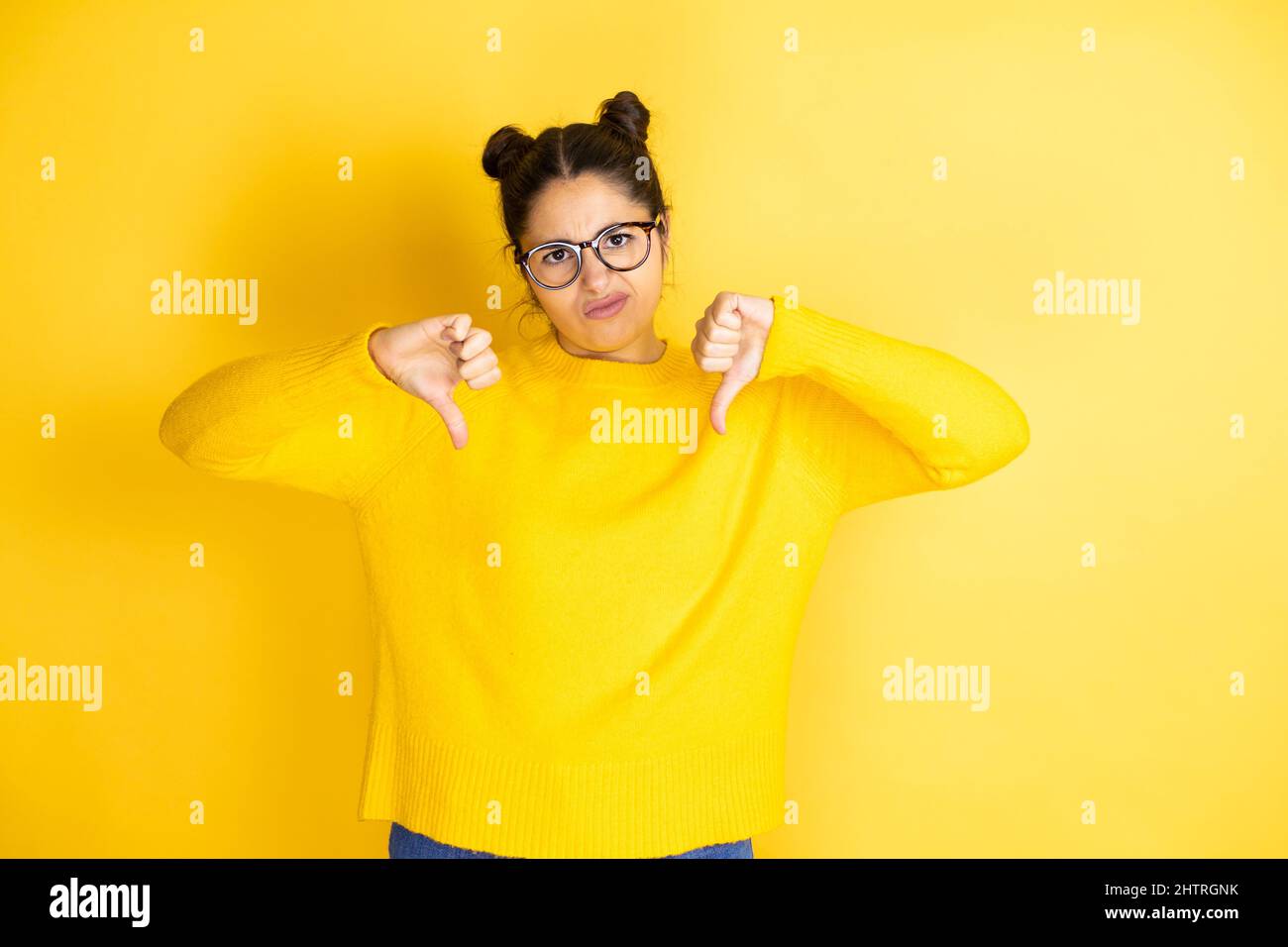 Young beautiful woman wearing casual sweater over isolated yellow ...