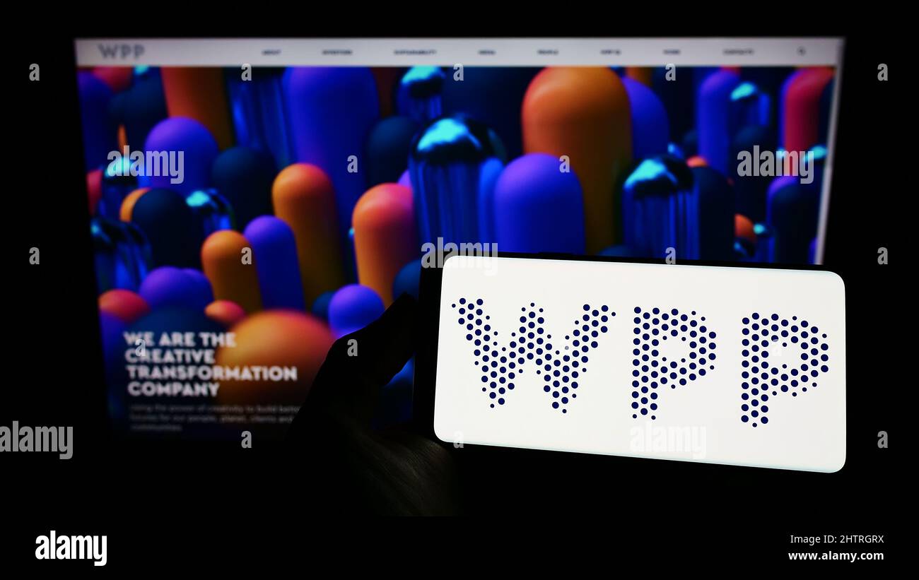Person holding smartphone with logo of British advertising company WPP ...