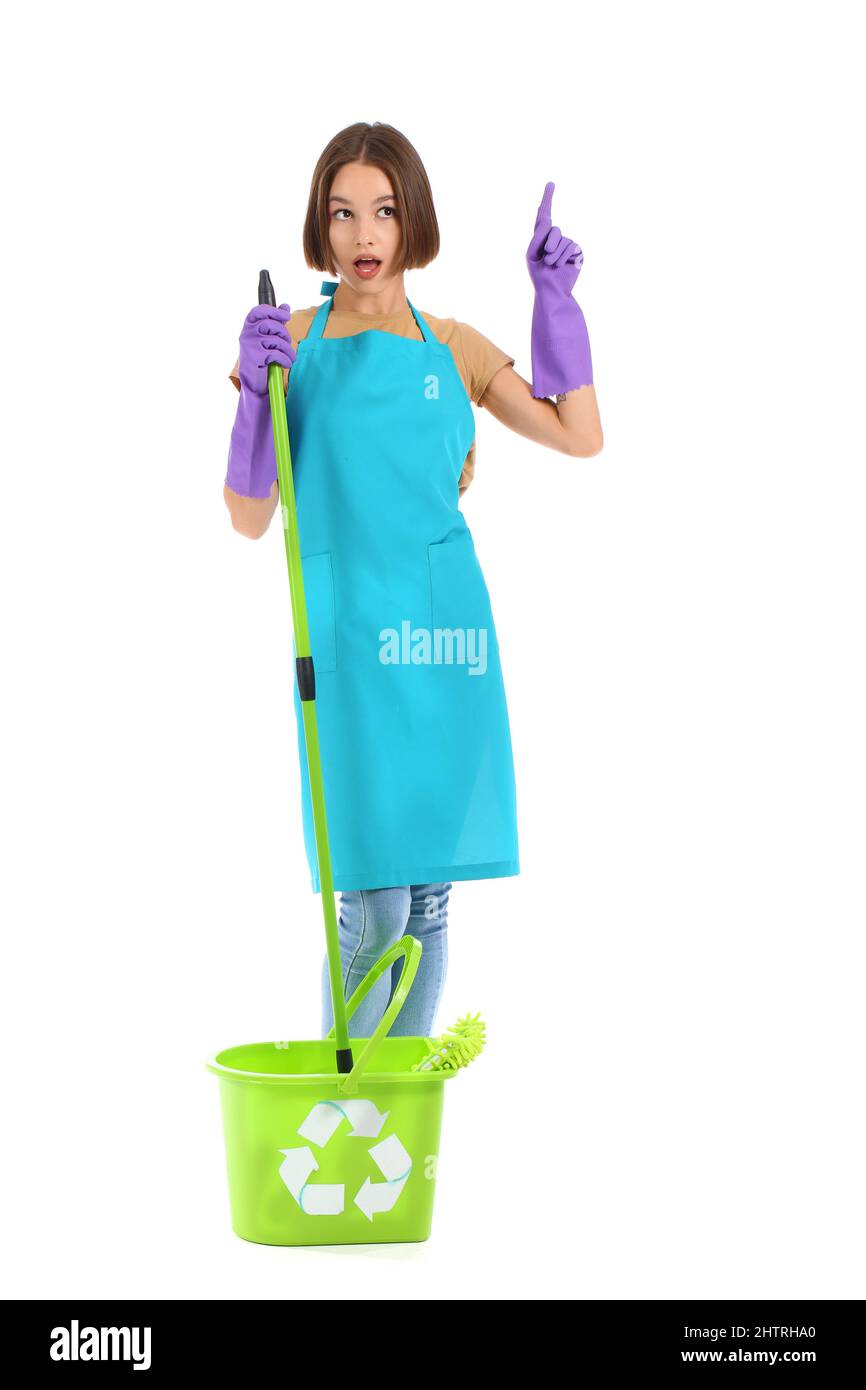 Beautiful young woman with floor mop and bucket pointing at something ...