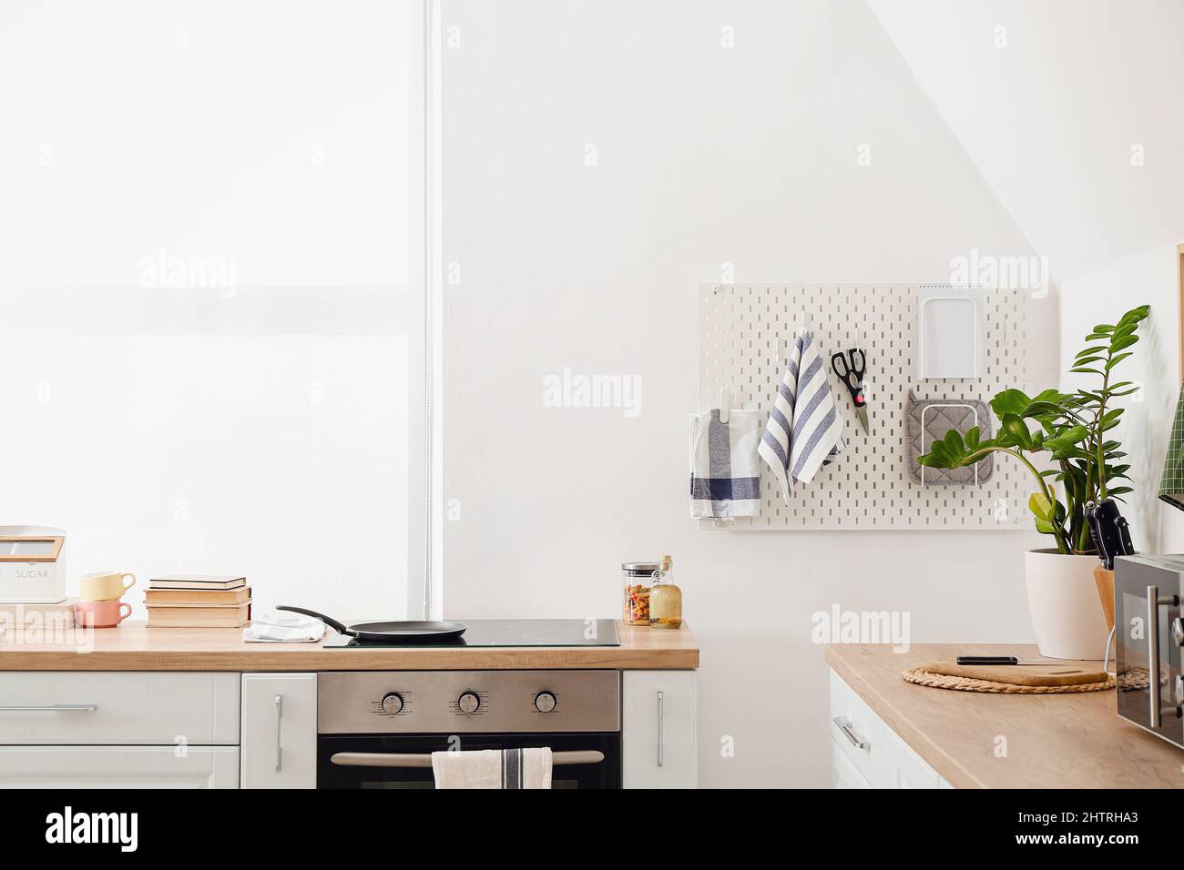 Stylish counters and pegboard in kitchen interior Stock Photo - Alamy