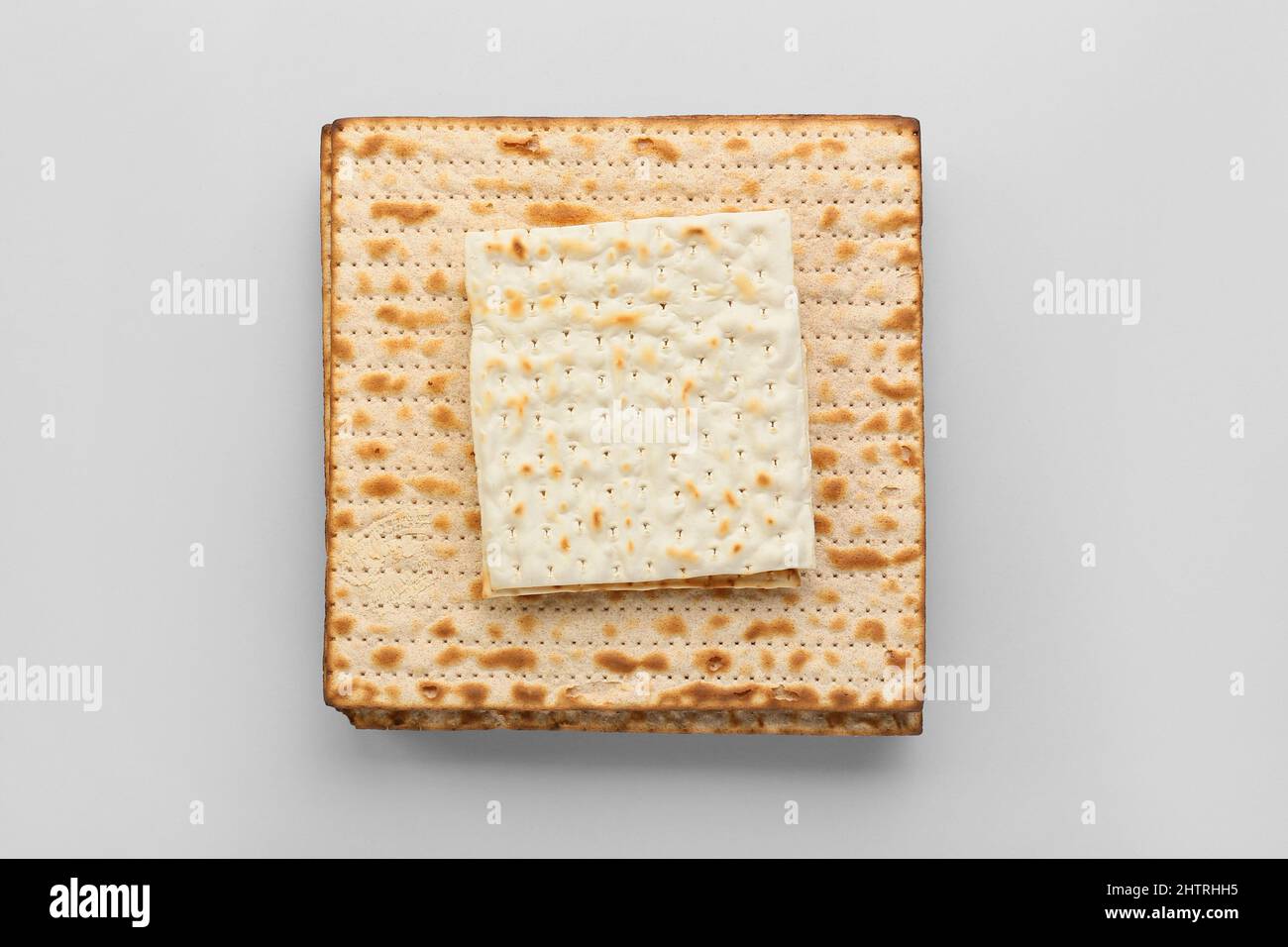 Jewish flatbread matza for Passover on light background, top view Stock ...