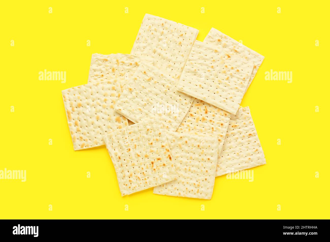 Jewish flatbread matza for Passover on yellow background Stock Photo ...