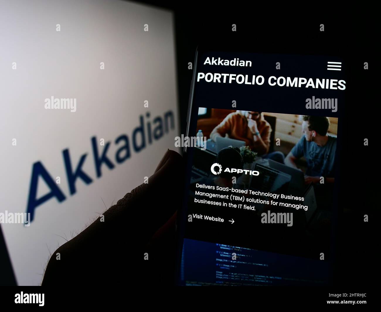Person holding cellphone with website of US investment company Akkadian Ventures Inc. on screen ...