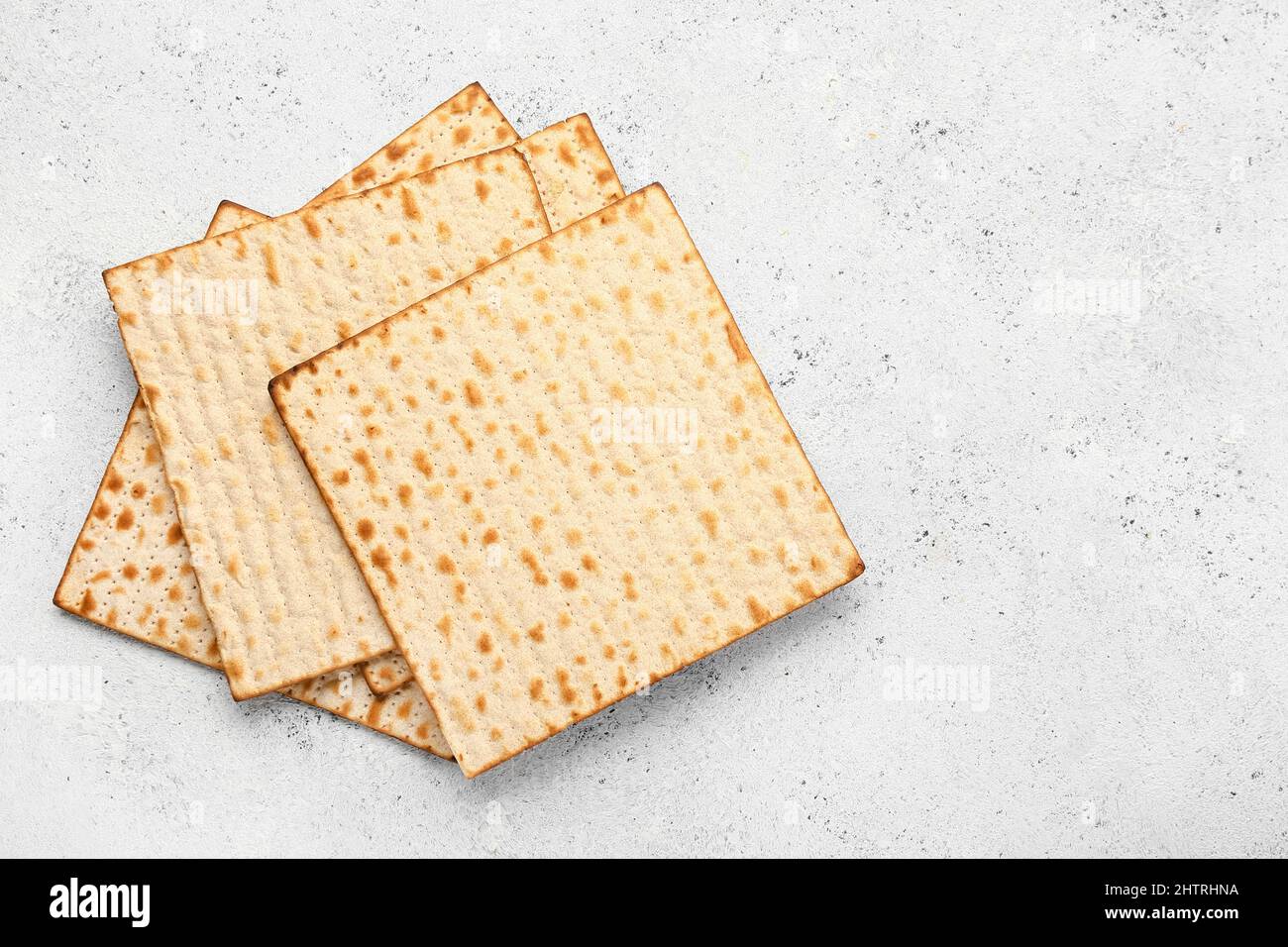 Jewish flatbread matza for Passover on light background, top view Stock ...