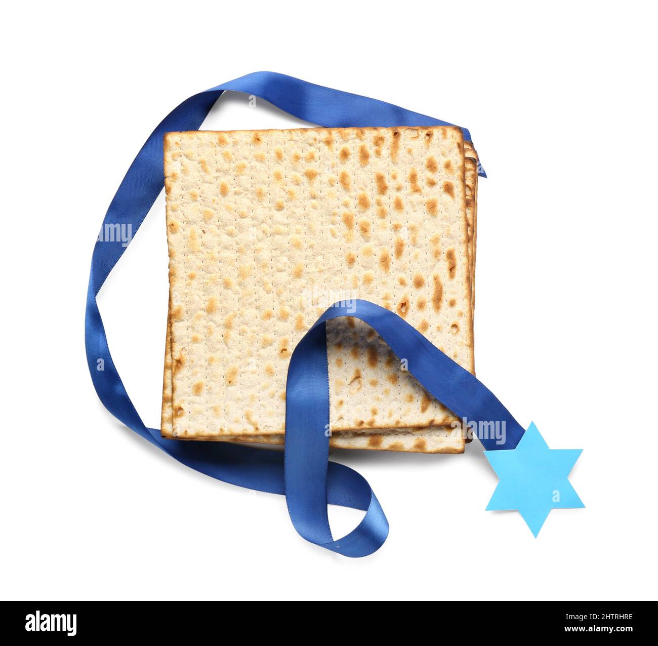 Jewish flatbread matza for Passover with ribbon and paper David star on ...