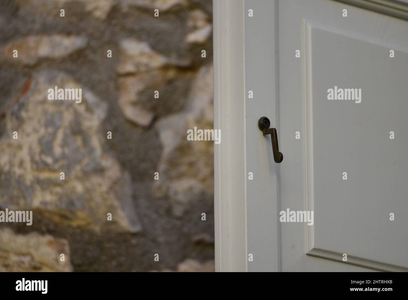 Traditional rural house antique white window shutter with a retro brass ...