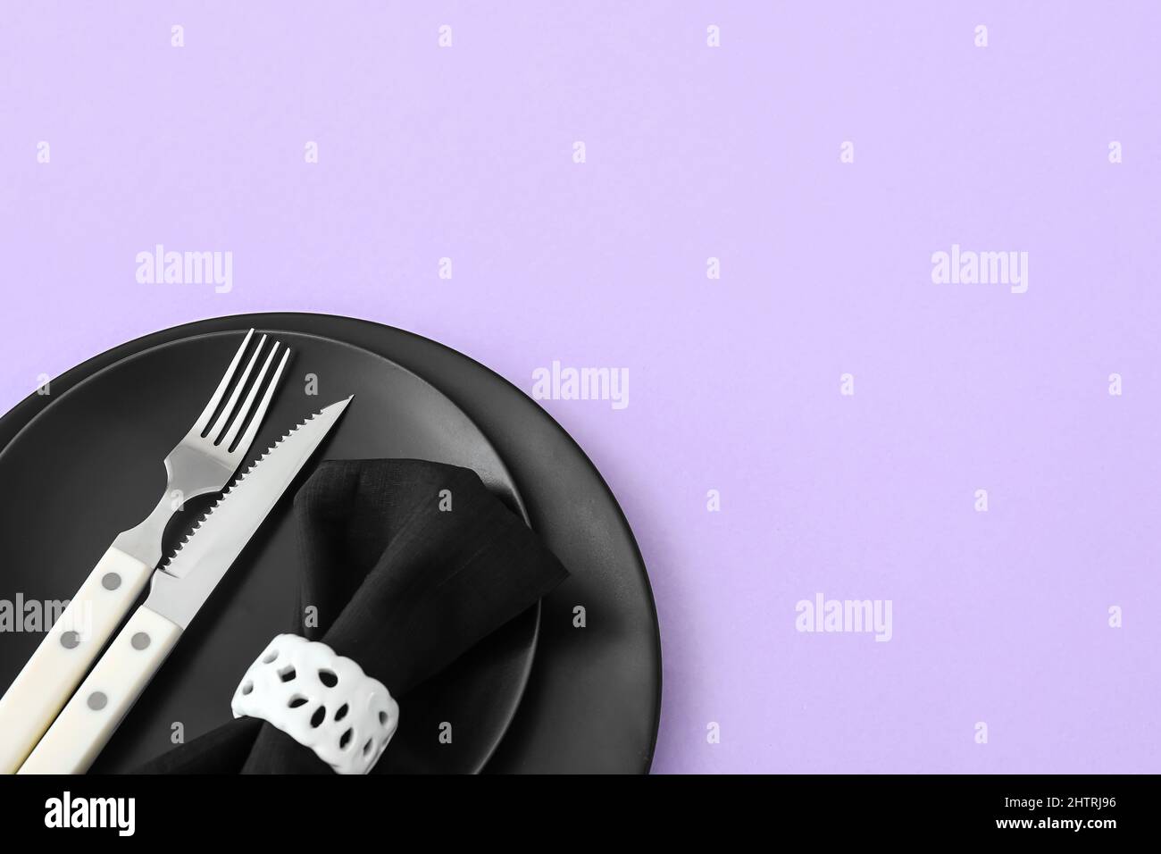 Simple table setting on purple background Stock Photo - Alamy