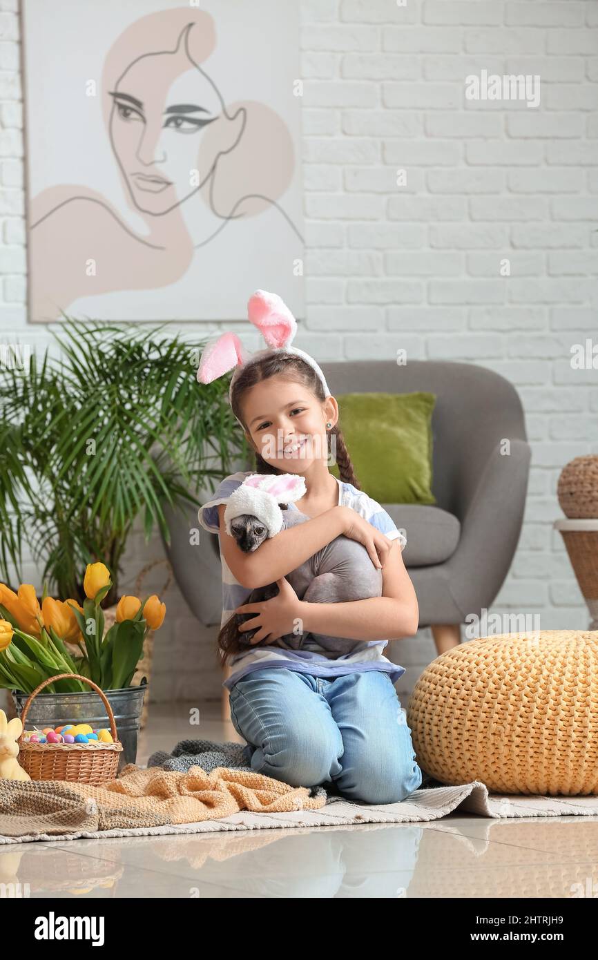 Little girl with Sphynx cat, Easter eggs and tulips at home Stock Photo ...
