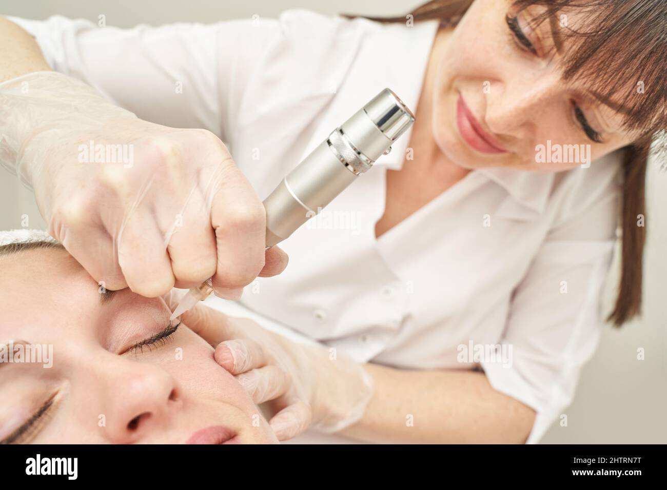 Permanent makeup. Beauty spa procedure. young woman. Face tattoo. Eye ...