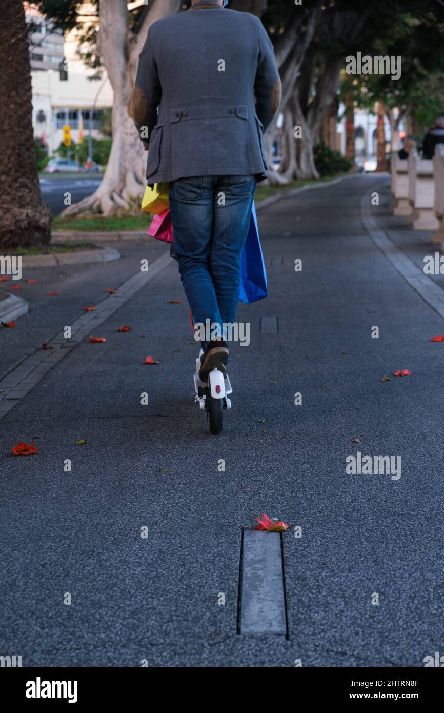 Man on his back on electric scooter Stock Photo - Alamy