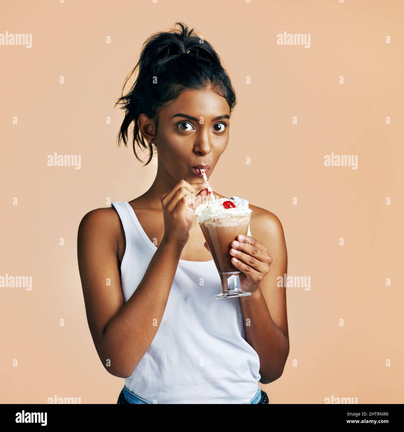 Milkshake is my favourite. Studio portrait of a beautiful young woman ...