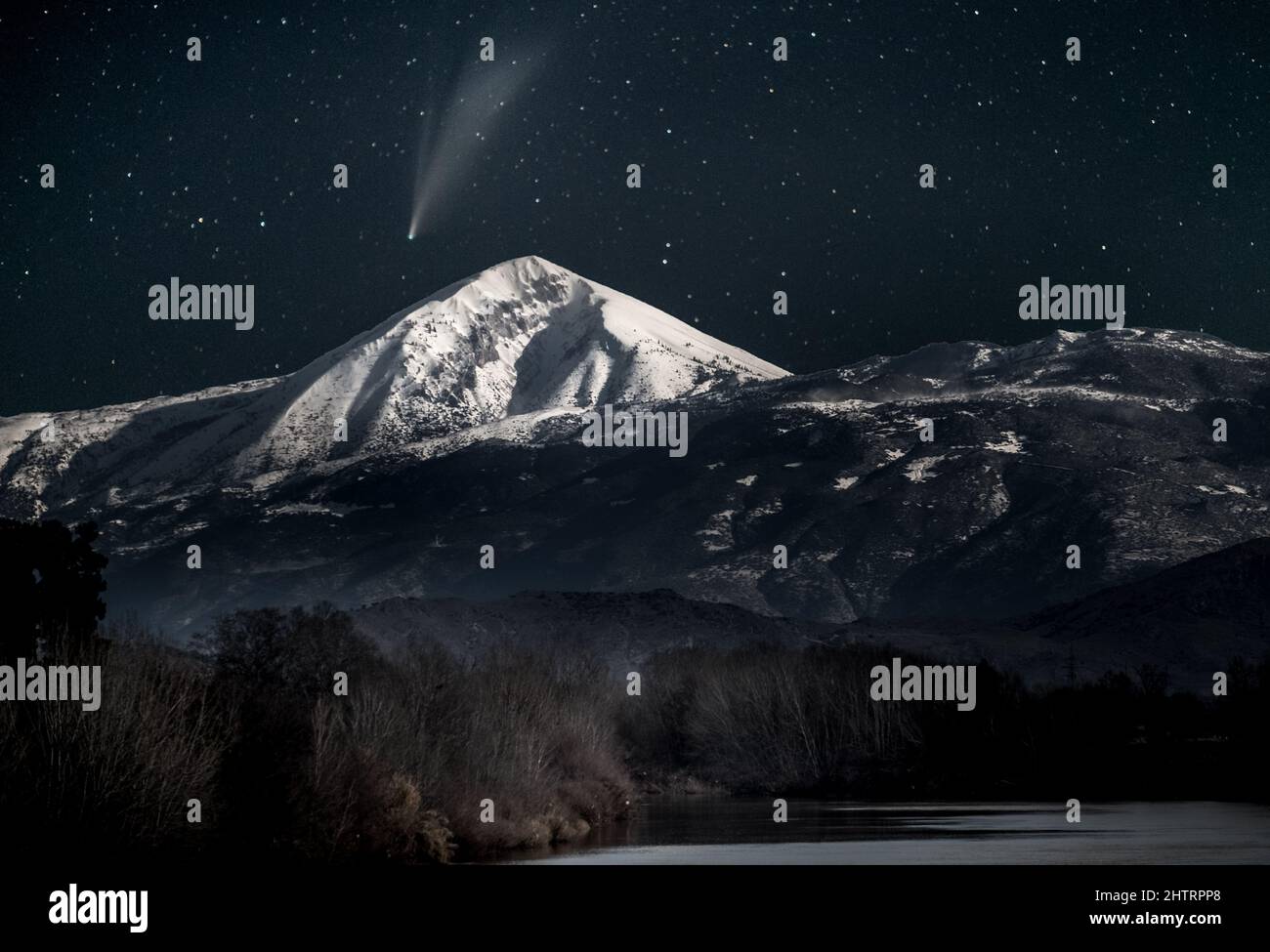Nightscape scenery with a comet crossing over a mountain Stock Photo ...