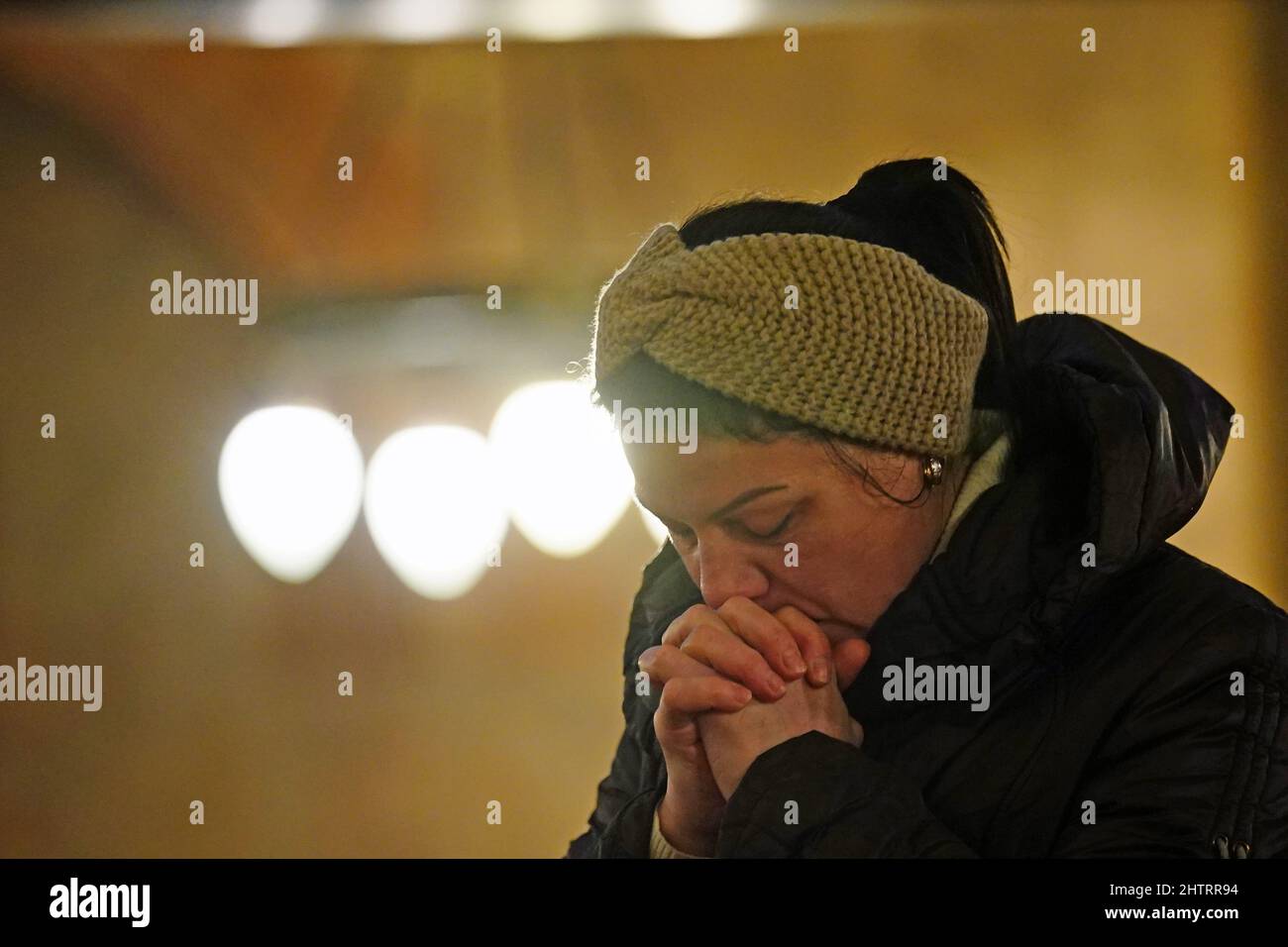 A person praying at the Ukrainian Catholic Cathedral of the Holy Family ...