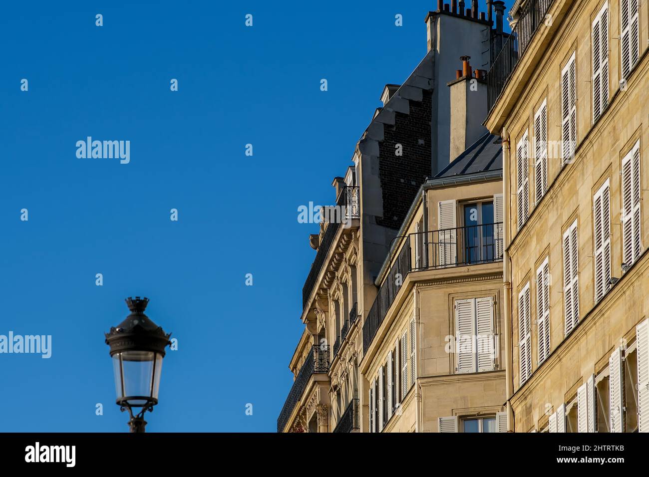 View of a lantern and a typical Parisian residential building with ...