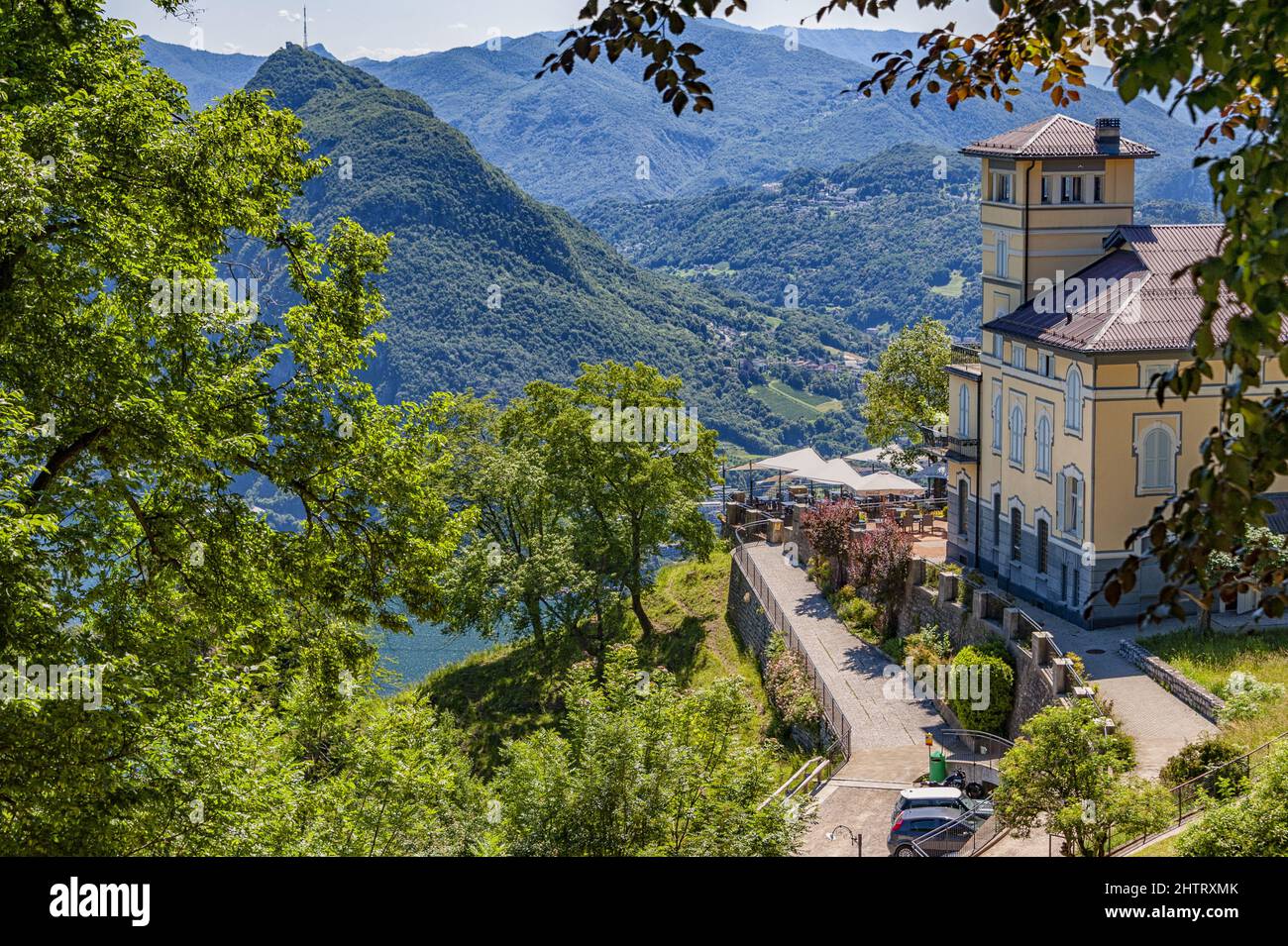 Beautiful aerial view of a building by green grass and Monte Bre ...