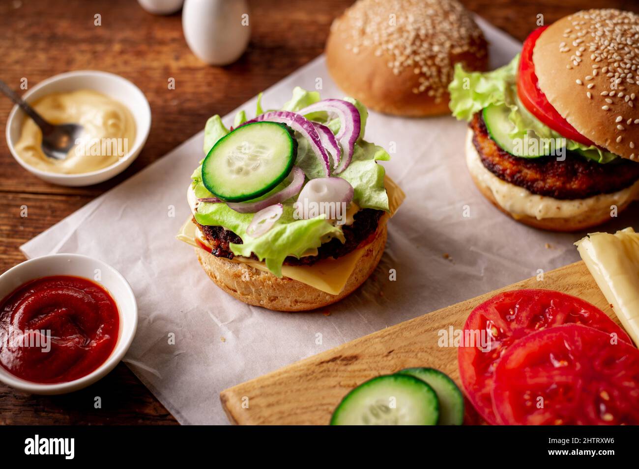 Cooking a hamburger. Stacking vegetables in a hamberger. The ...