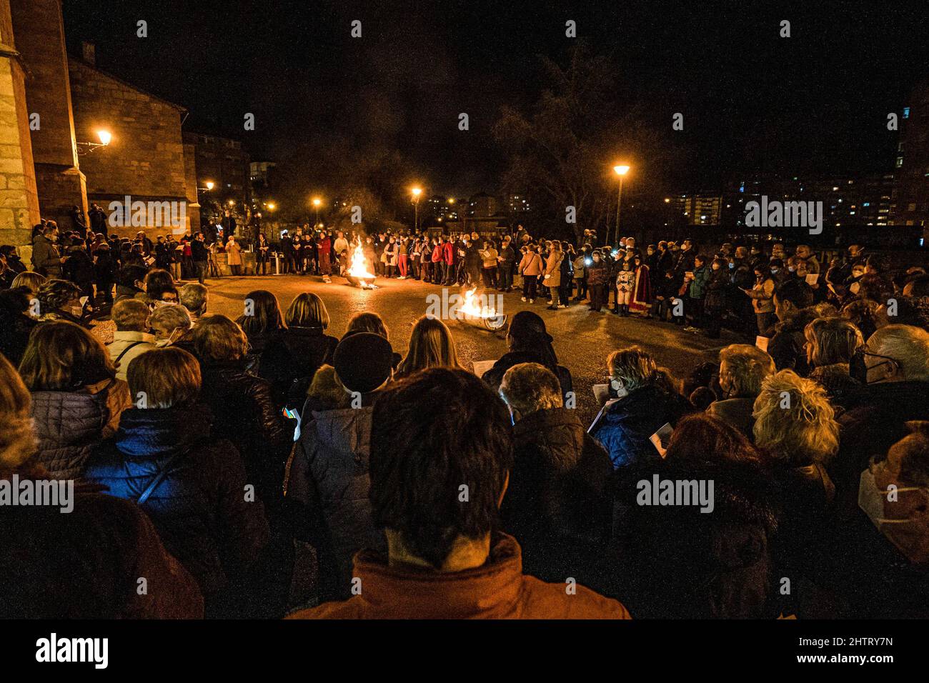 A large group of people sing around bonfires during the traditional ...