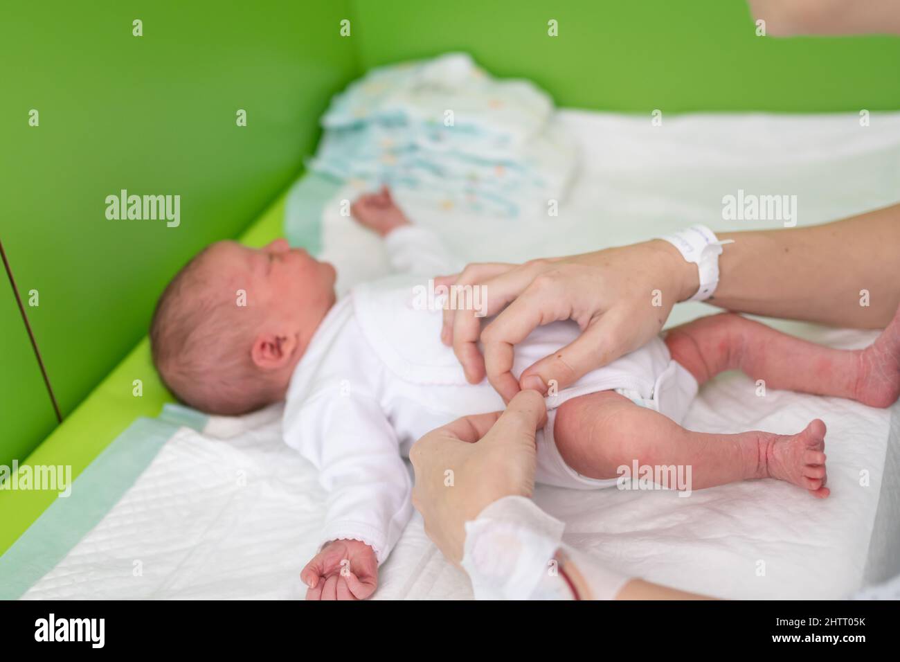 hands of a mom who just gave birth in the maternity hospital with the ...