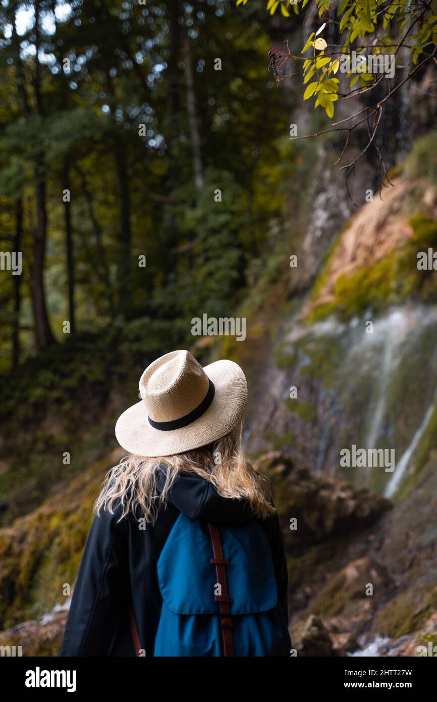 Vertical back view of a female hiking in a forest Stock Photo - Alamy