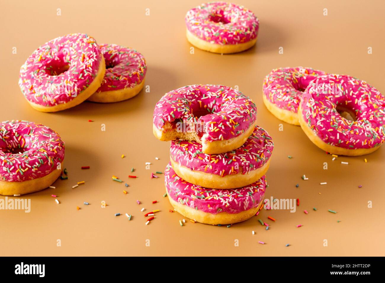 Group of pink frosted donuts with colorful sprinkles Stock Photo - Alamy
