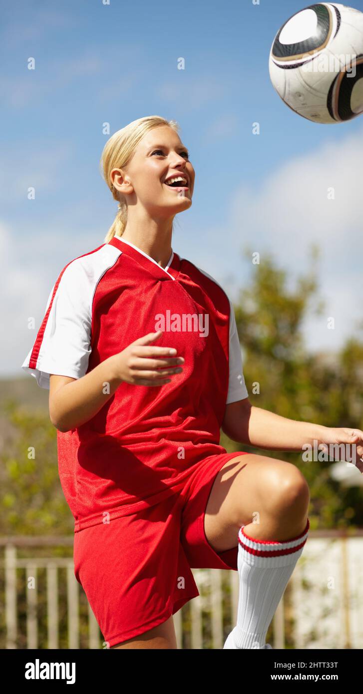 Shes getting better and better. Shot of a female soccer player kicking ...