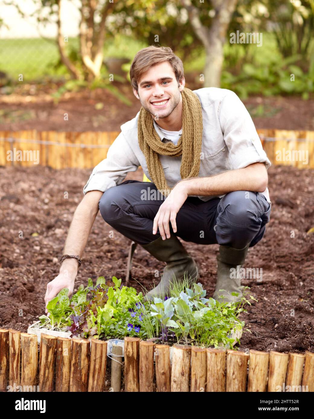 Excited to plant some vegetables. Handsome young guy getting ready to ...