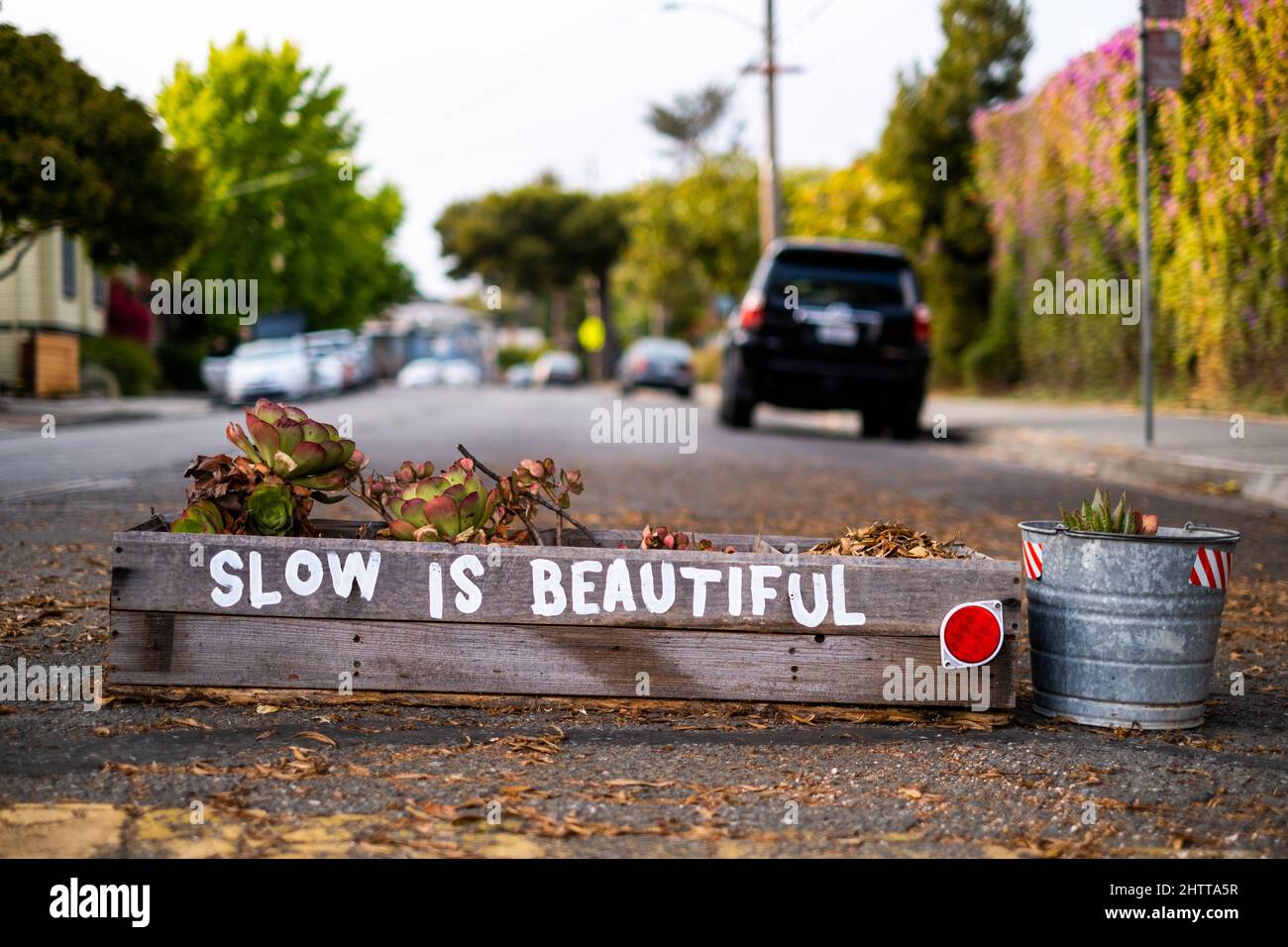 Slow is beautiful sign in Oakland streets Stock Photo - Alamy