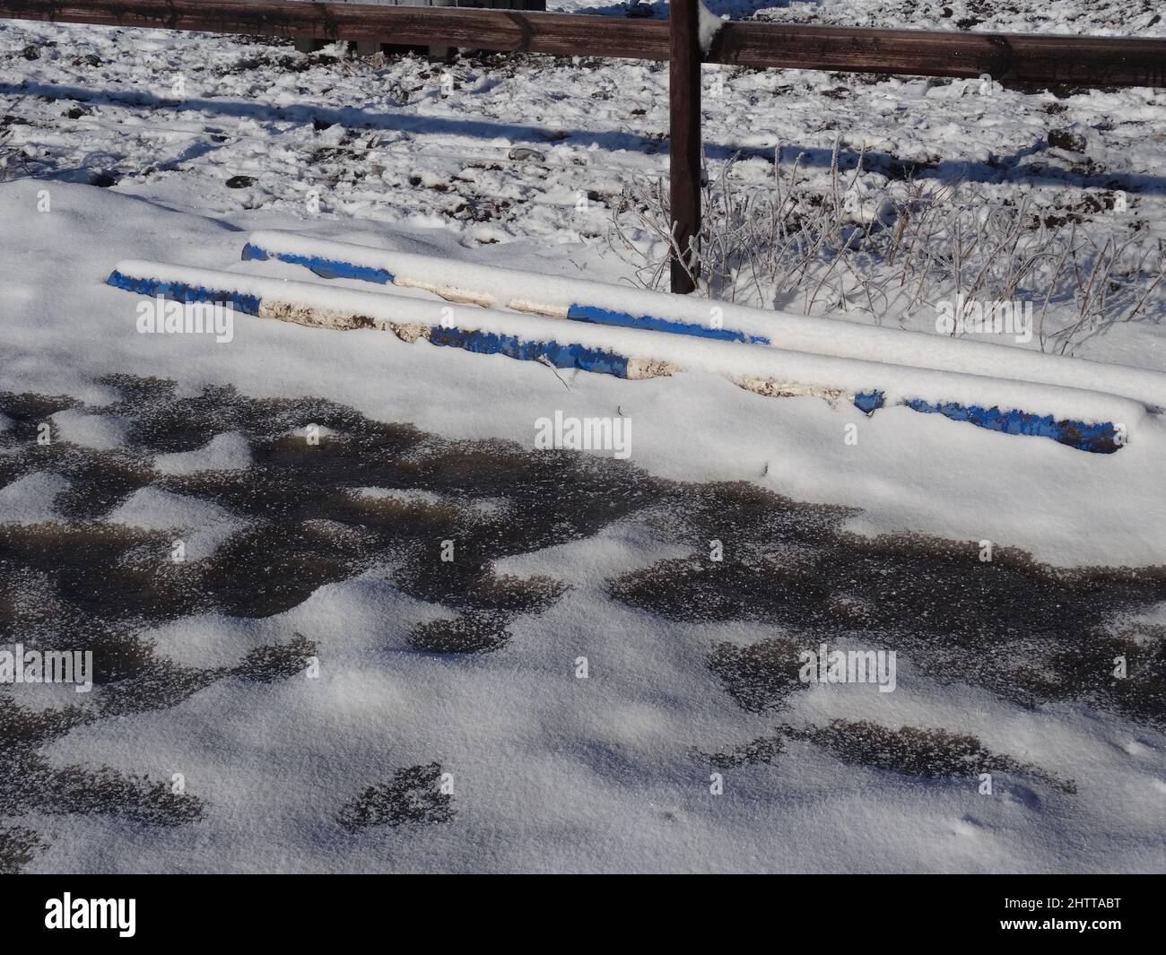 Blue and white obstacle bars covered with snow Stock Photo - Alamy