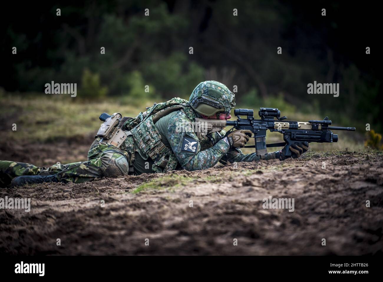 Dutch soldier in a new uniform in NFP camouflage lying on the ground ...