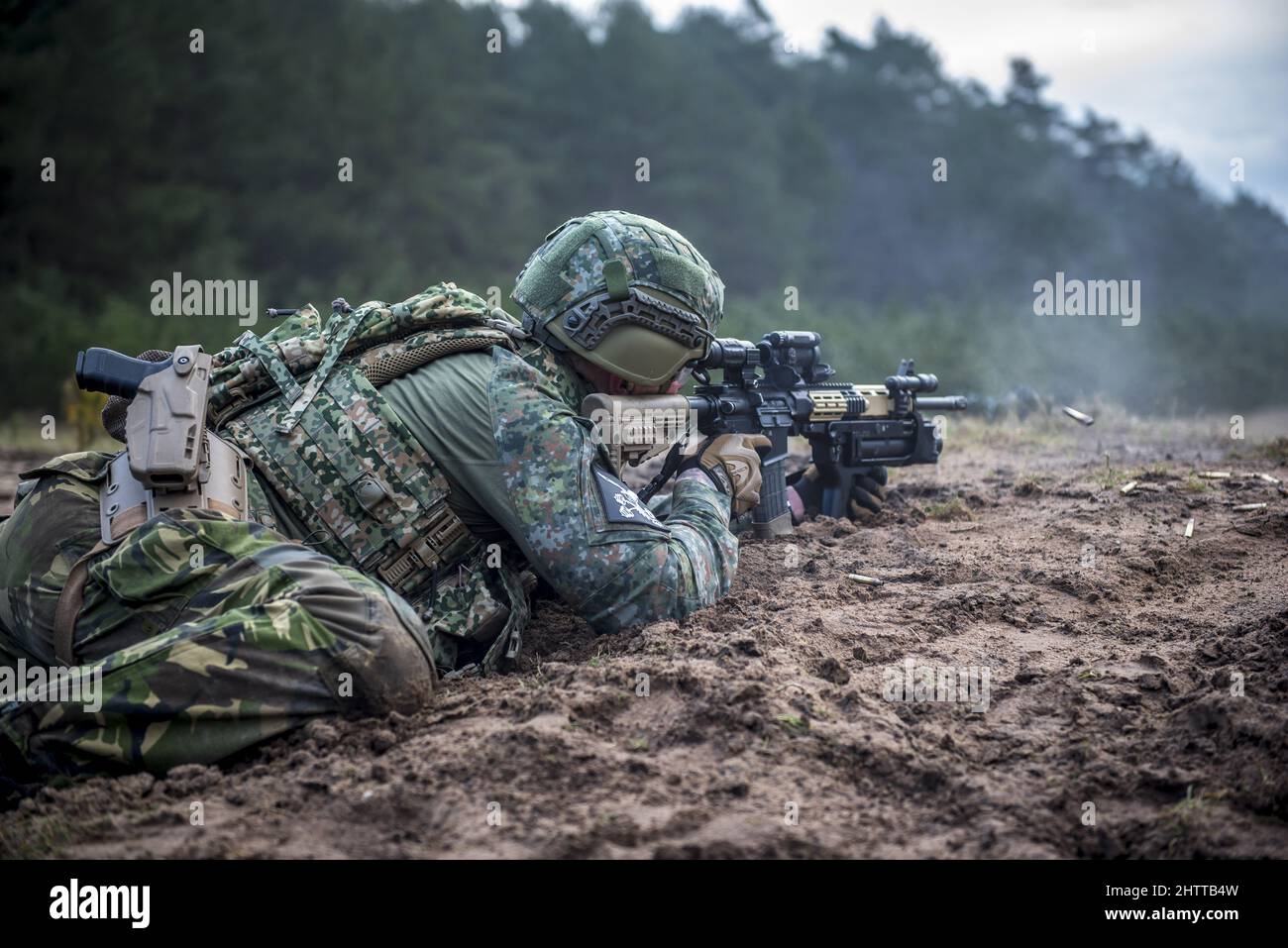 Soldier lying on ground gun hi-res stock photography and images - Alamy