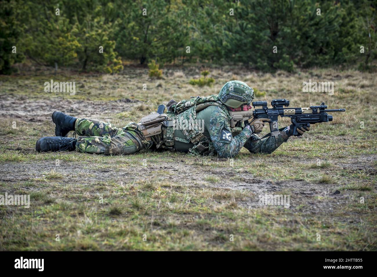 Dutch soldier in a new uniform in NFP camouflage lying on the ground ...