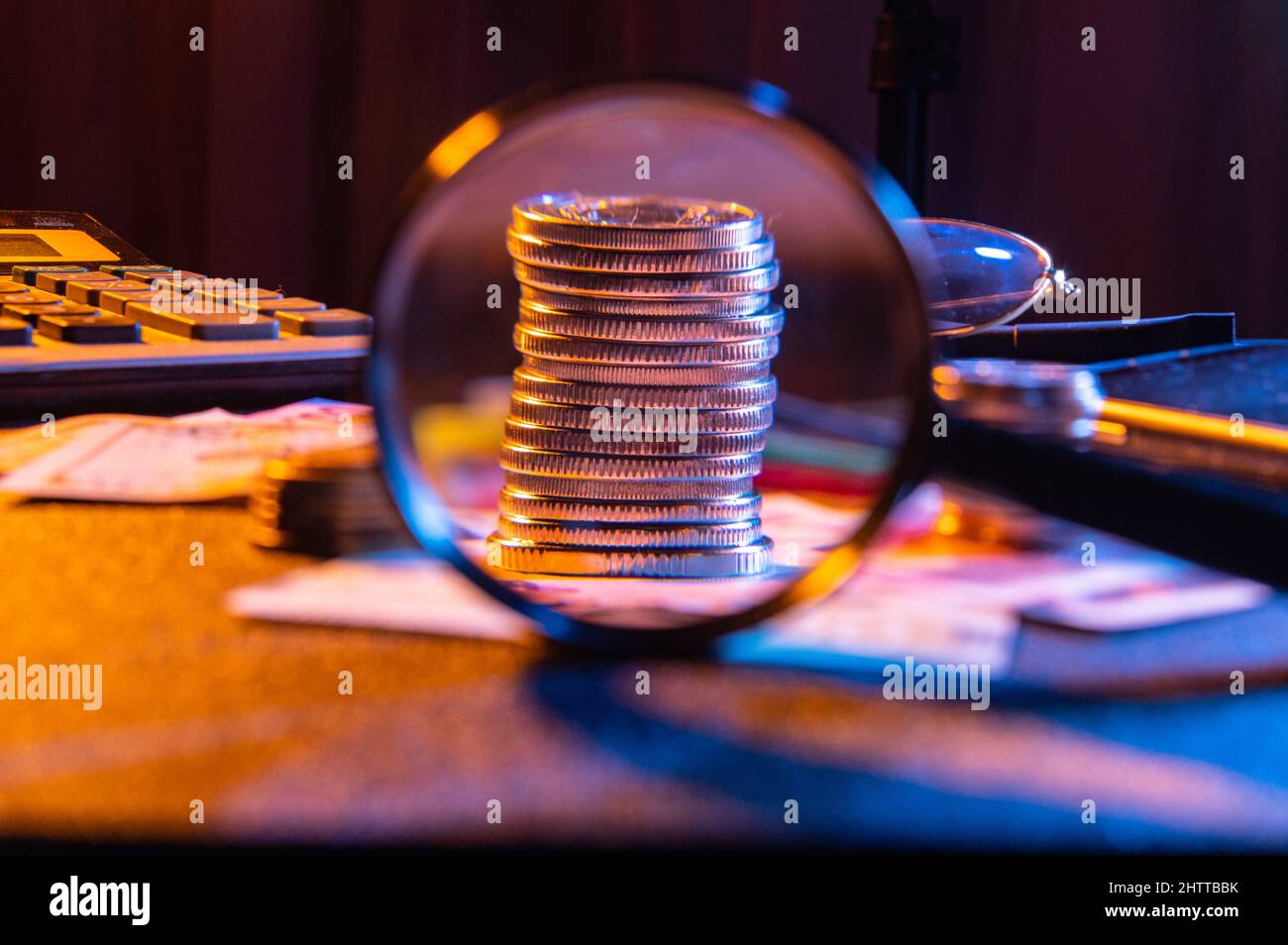 A stack of iron money. View of a small change through a magnifying ...