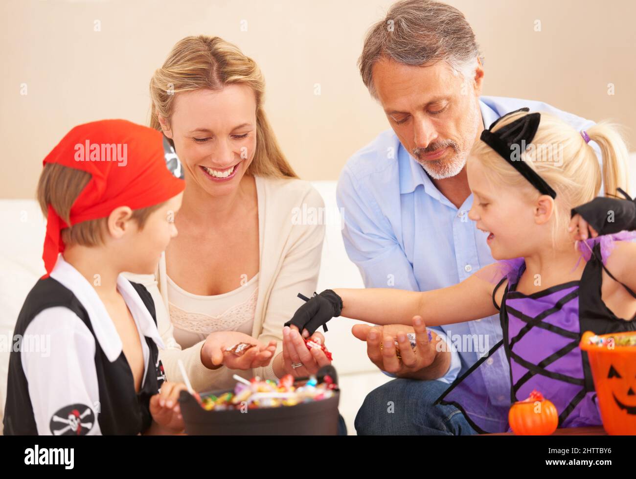 Family ready to feast. A family sitting together and sharing sweets on ...