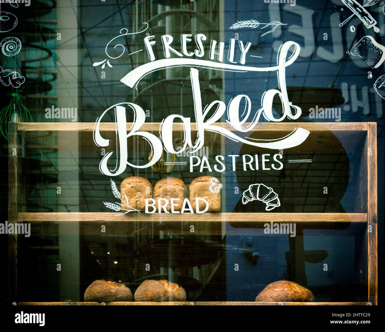 Fresh loaves of bread on display in a bakers window. The window ...