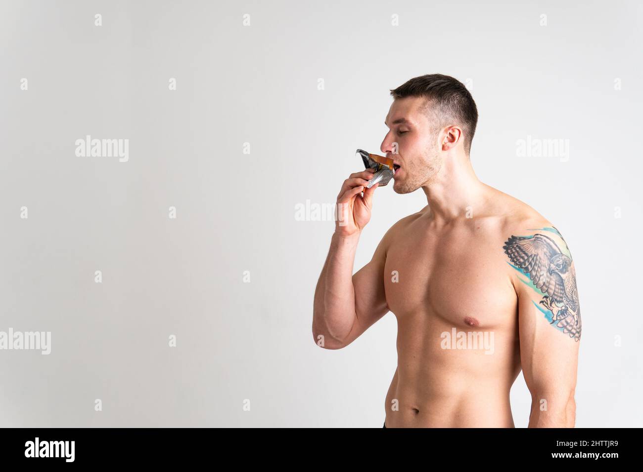 Man eats protein bar on white background isolated bar snack eat ...