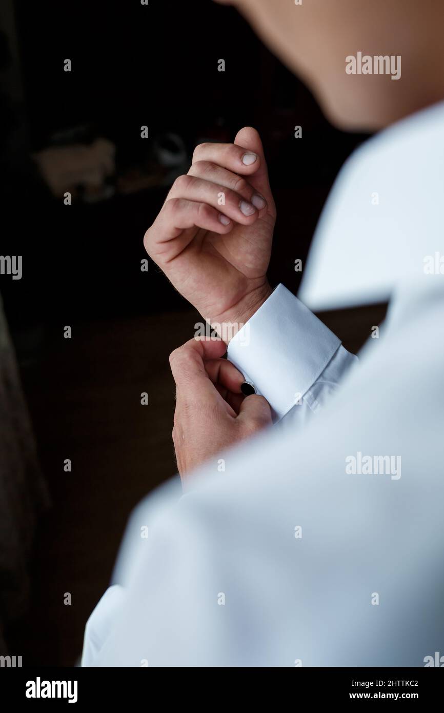 A man fastens a cufflink on his shirt Stock Photo - Alamy