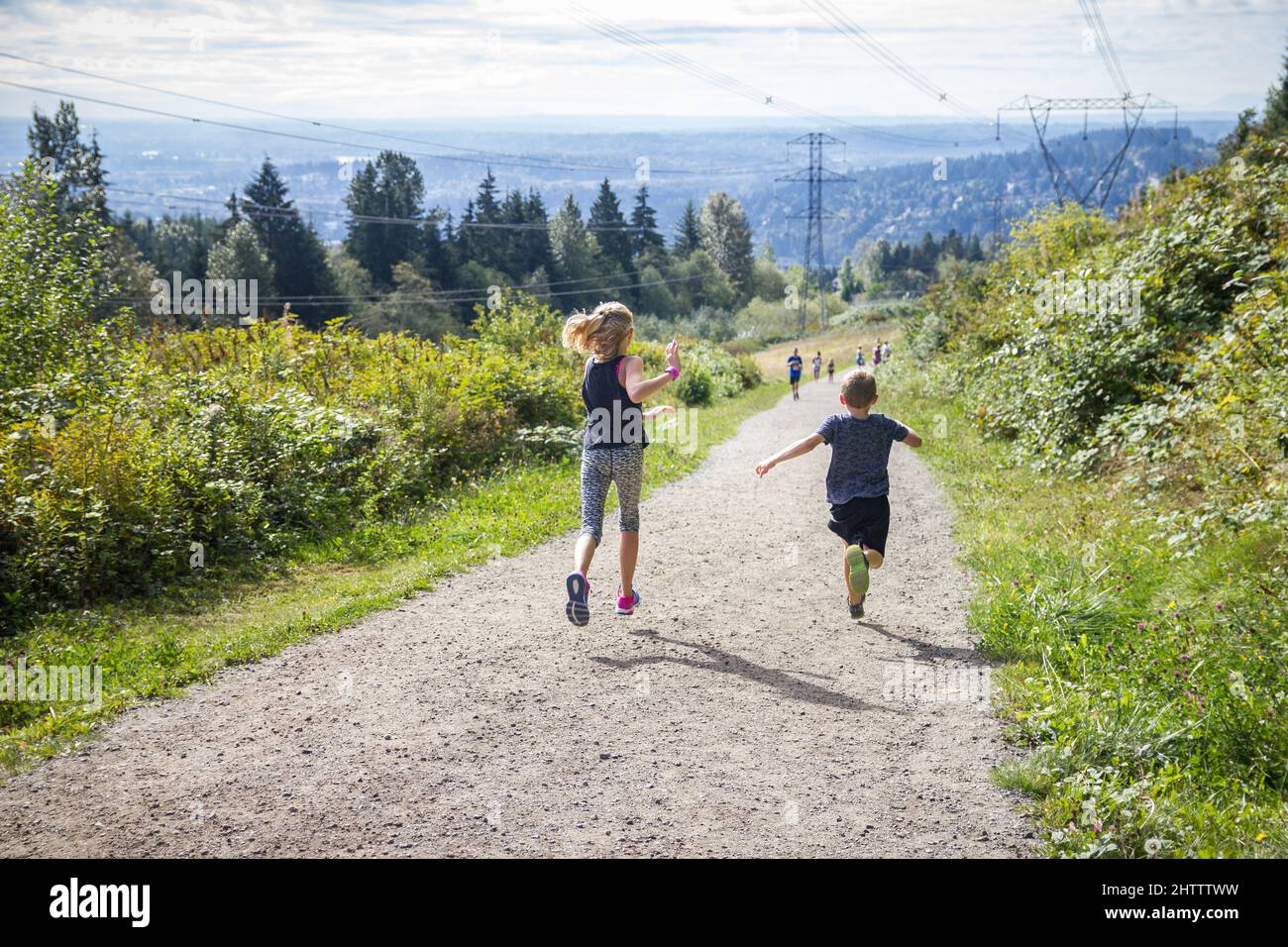 Back view of children running on a road Stock Photo - Alamy