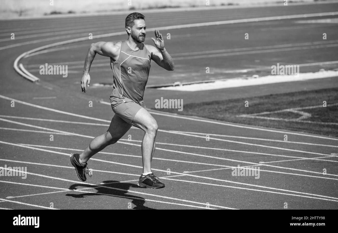 Dynamic movement of male runner on running track, run Stock Photo - Alamy